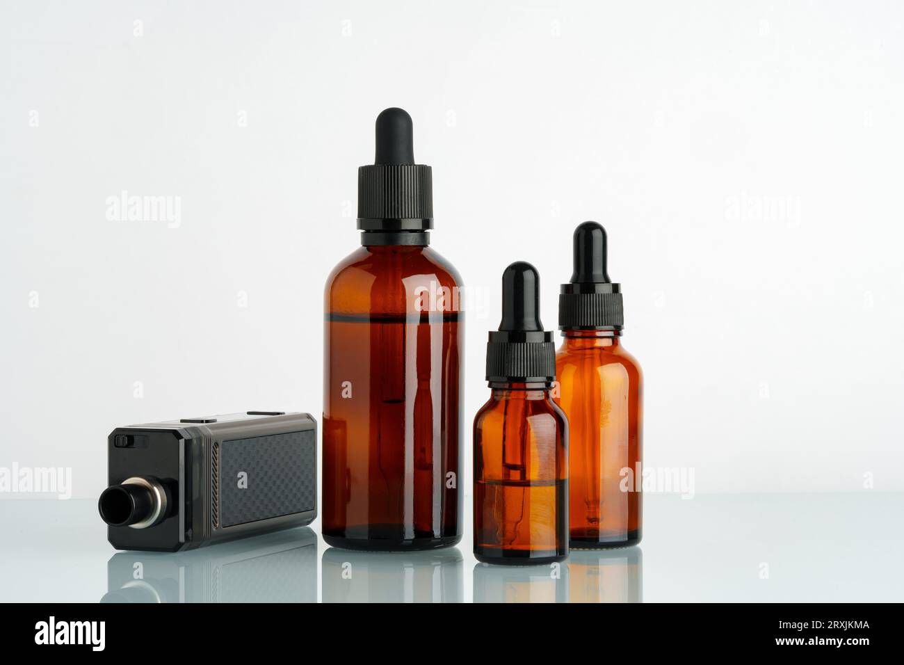 Electronic cigarette with smoking liquid bottle on white background ...