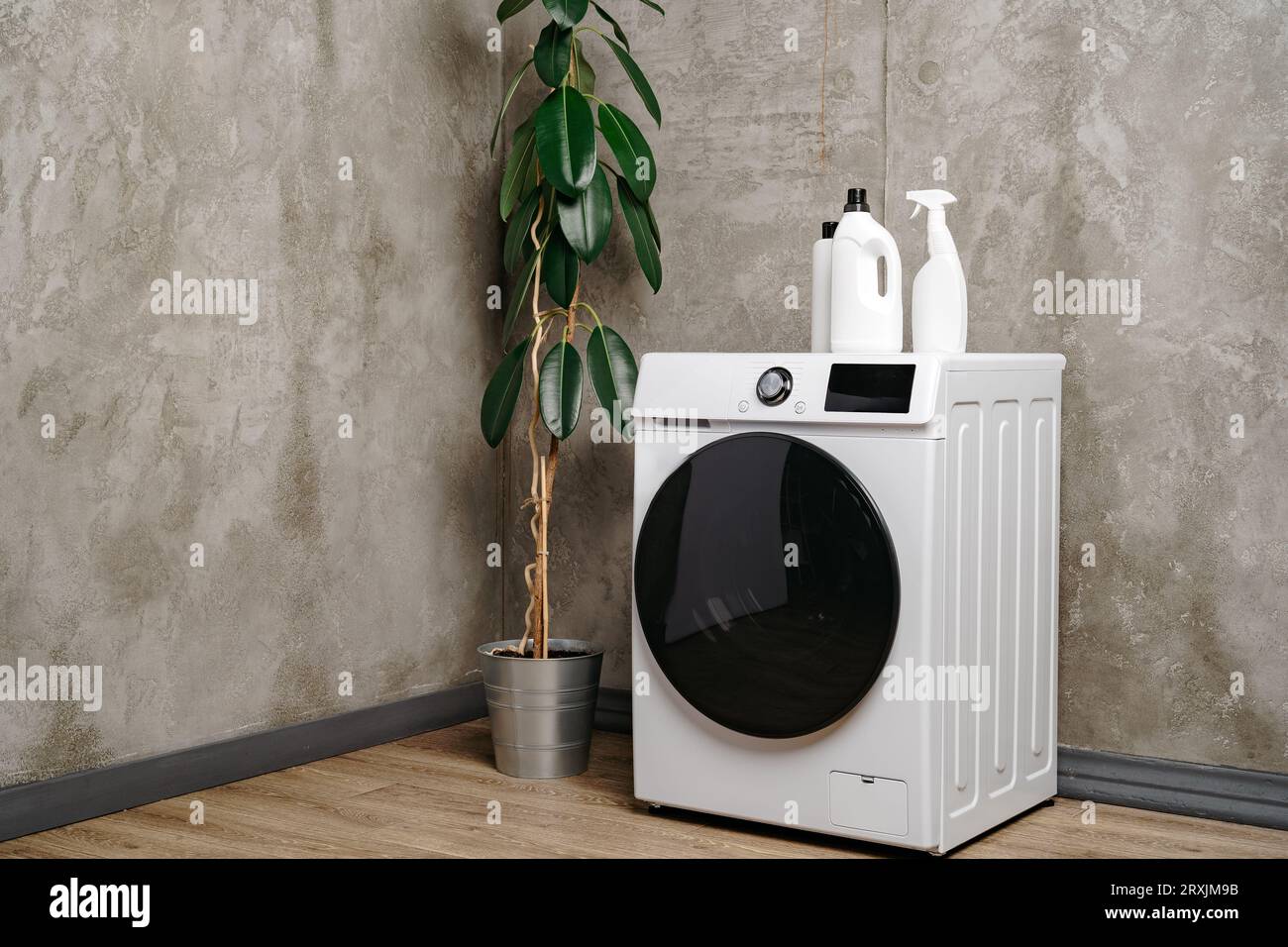 Washing machine in a gray modern laundry room Stock Photo - Alamy