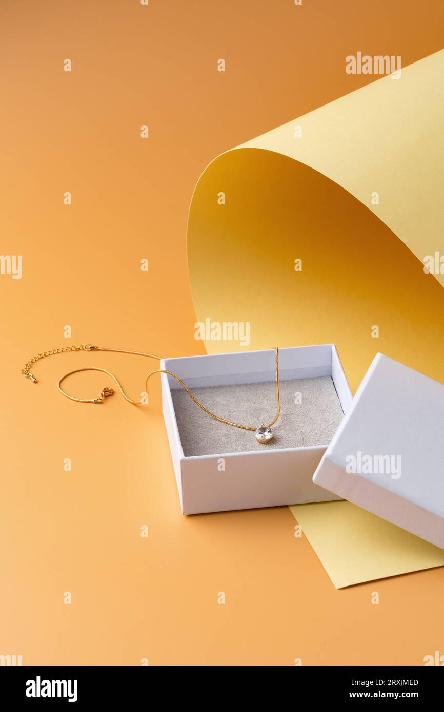 White jewelry box on yellow studio background Stock Photo - Alamy