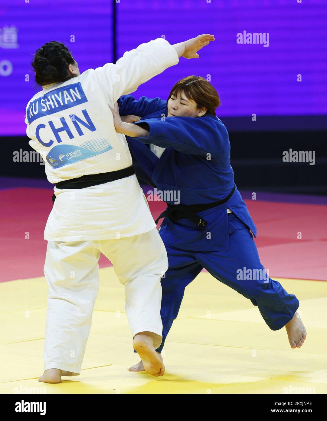 Japan's Wakaba Tomita (blue) competes against Xu Shiyan of China in the ...