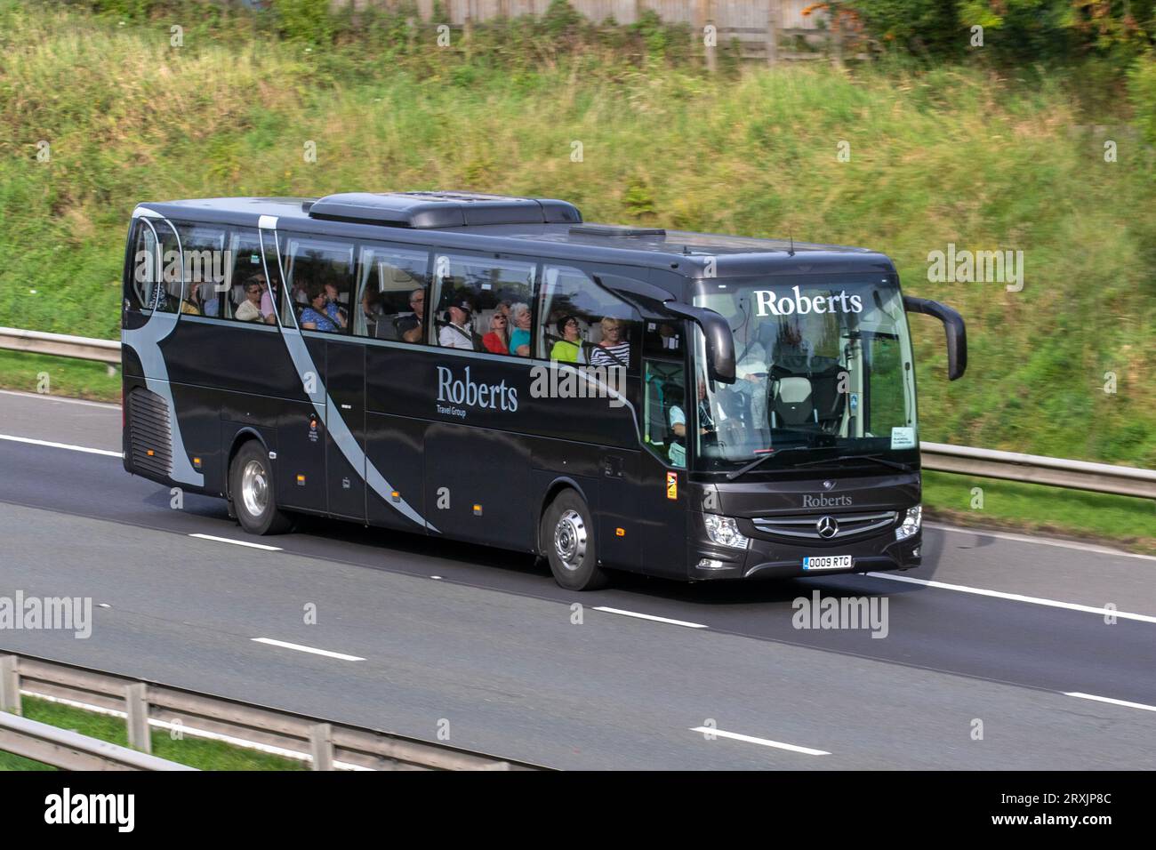 Roberts Coaches Limited single-decker travelling at speed on the M6 ...