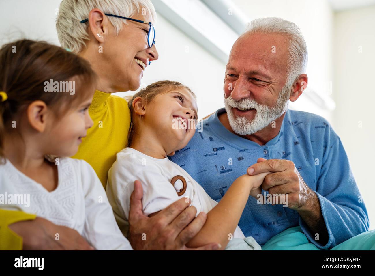 Happy grandchildren visiting grandfather at hospital ward. Support ...