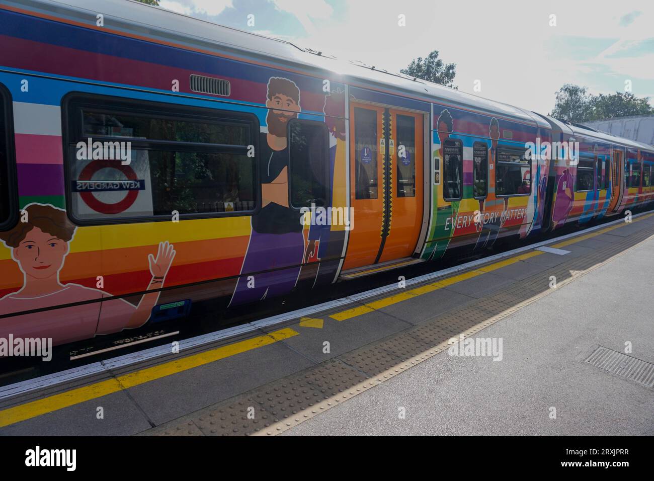 A TfL Overground train in a colourful painting scheme at Kew station, UK Stock Photo - Alamy