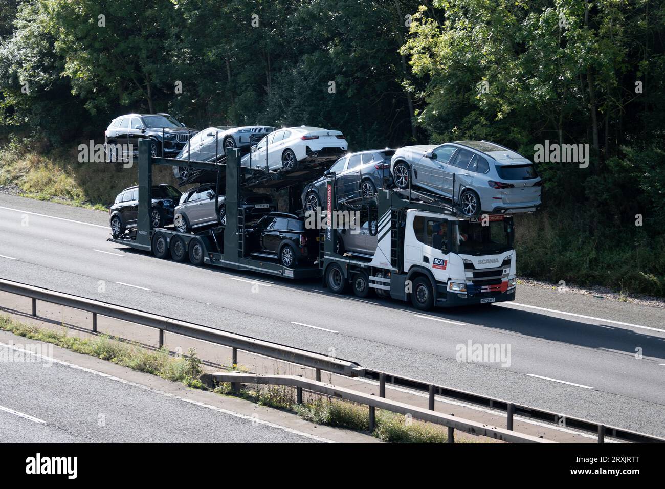 BCA Automotive transporter lorry carrying new BMW cars on the M40 ...
