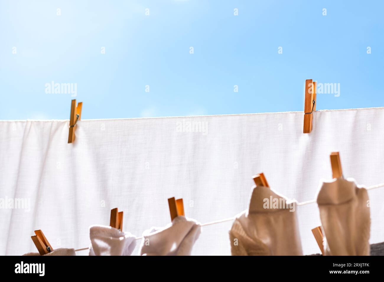 From below laundry white and gray colored clothes hanging on ...