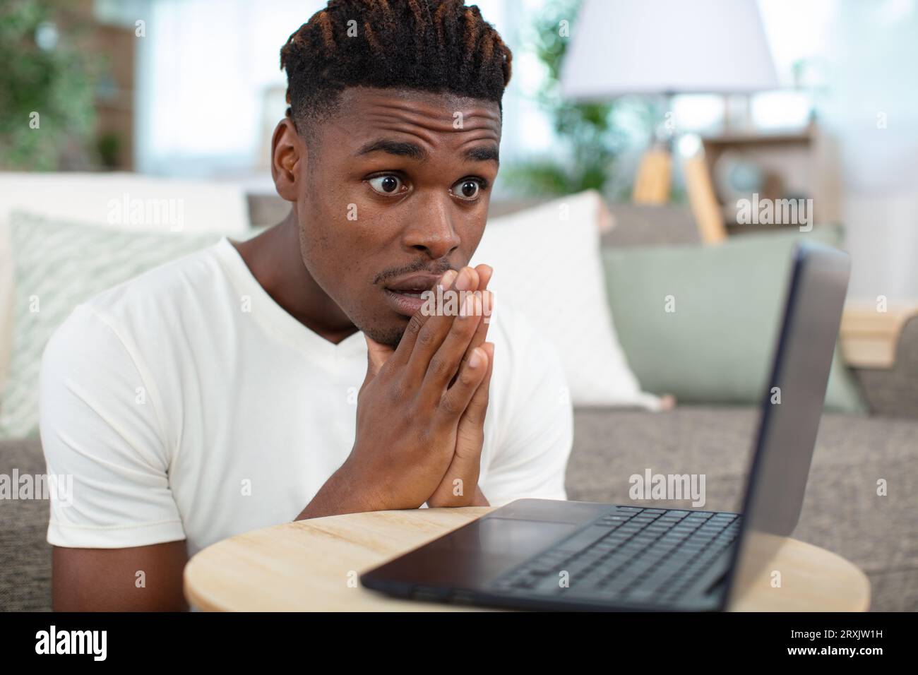man looking at computer screen in shock Stock Photo - Alamy