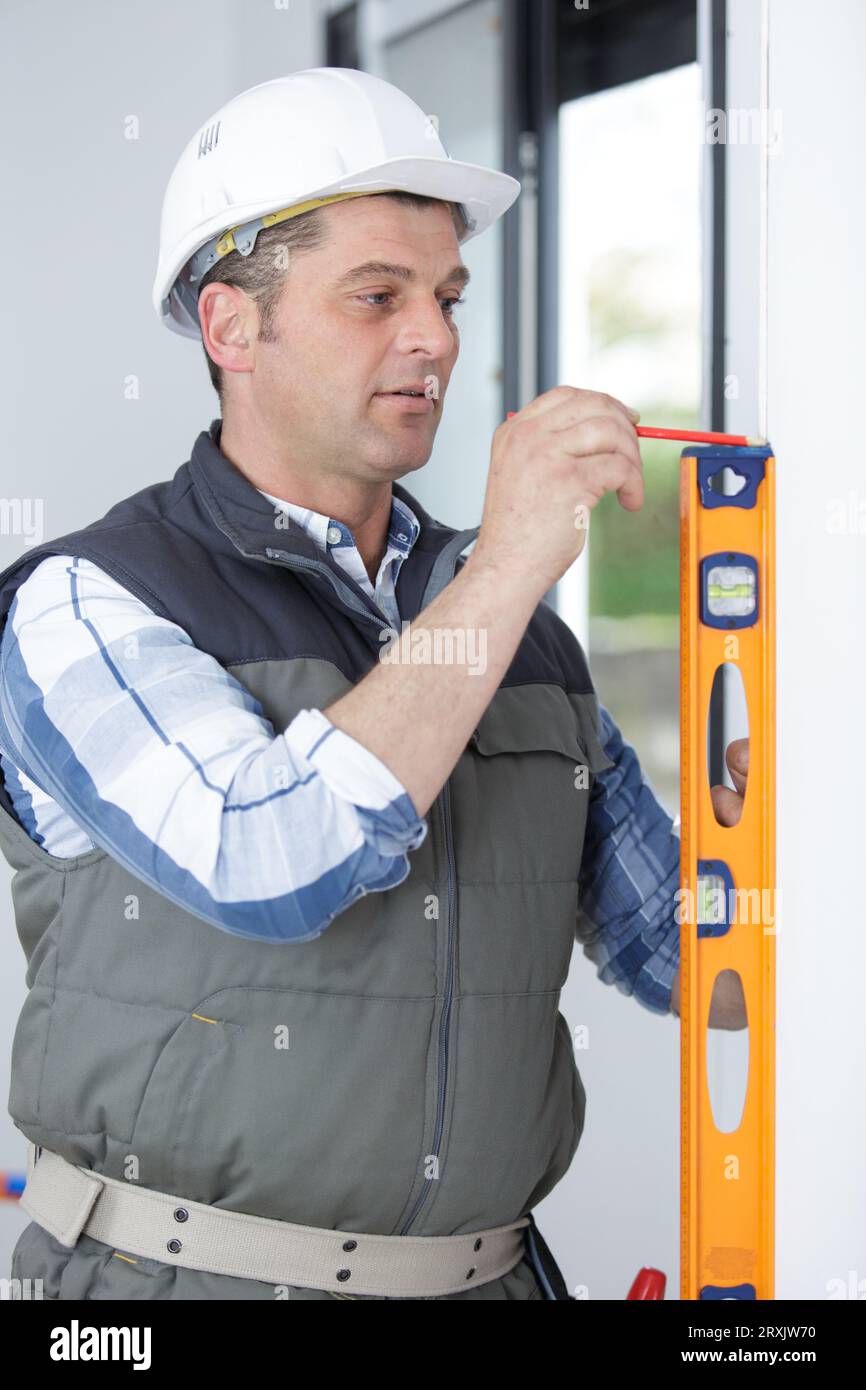 Worker using level tool device hi-res stock photography and images - Alamy