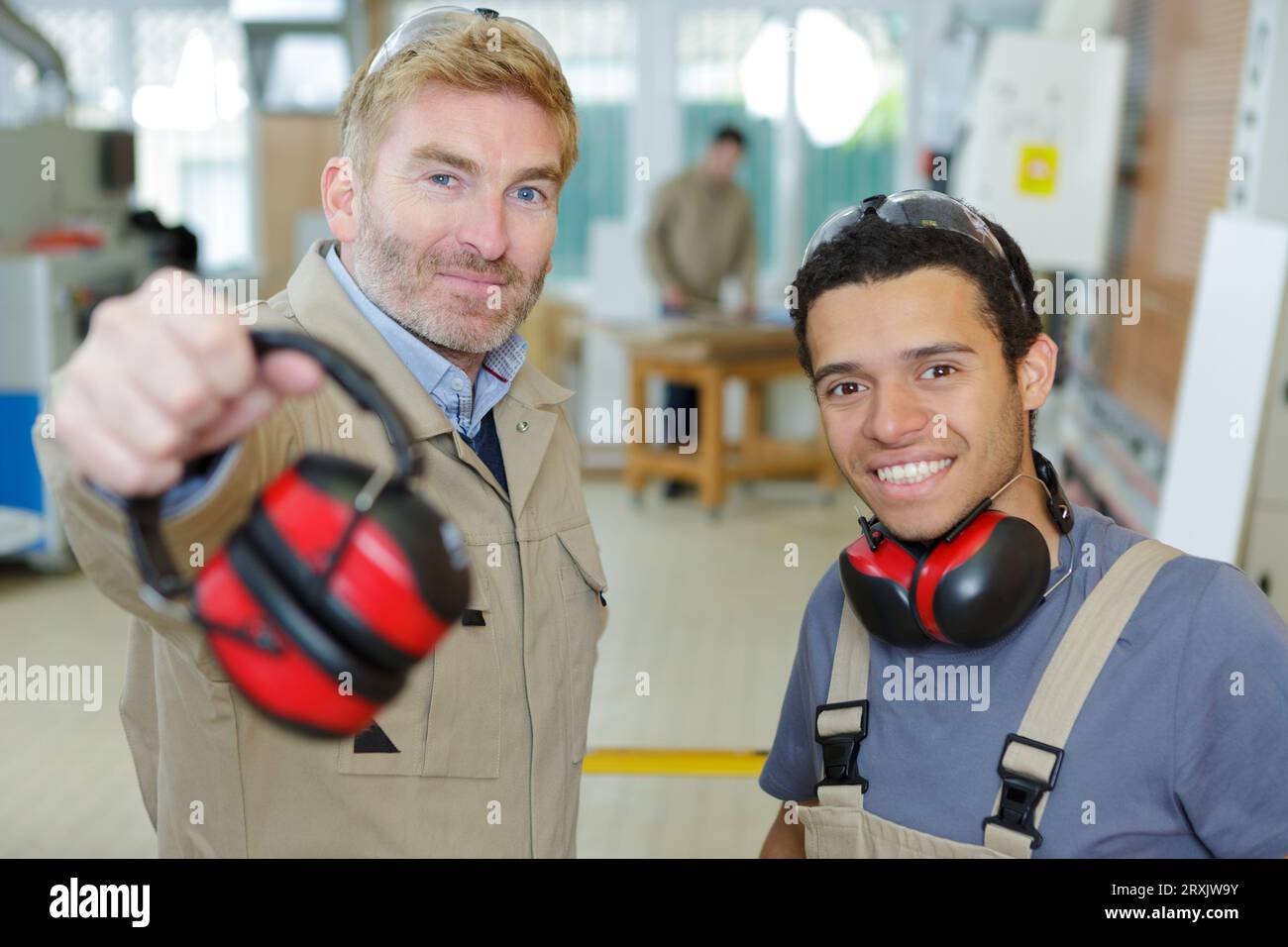 two men in workwear in a carpenters workshop Stock Photo - Alamy