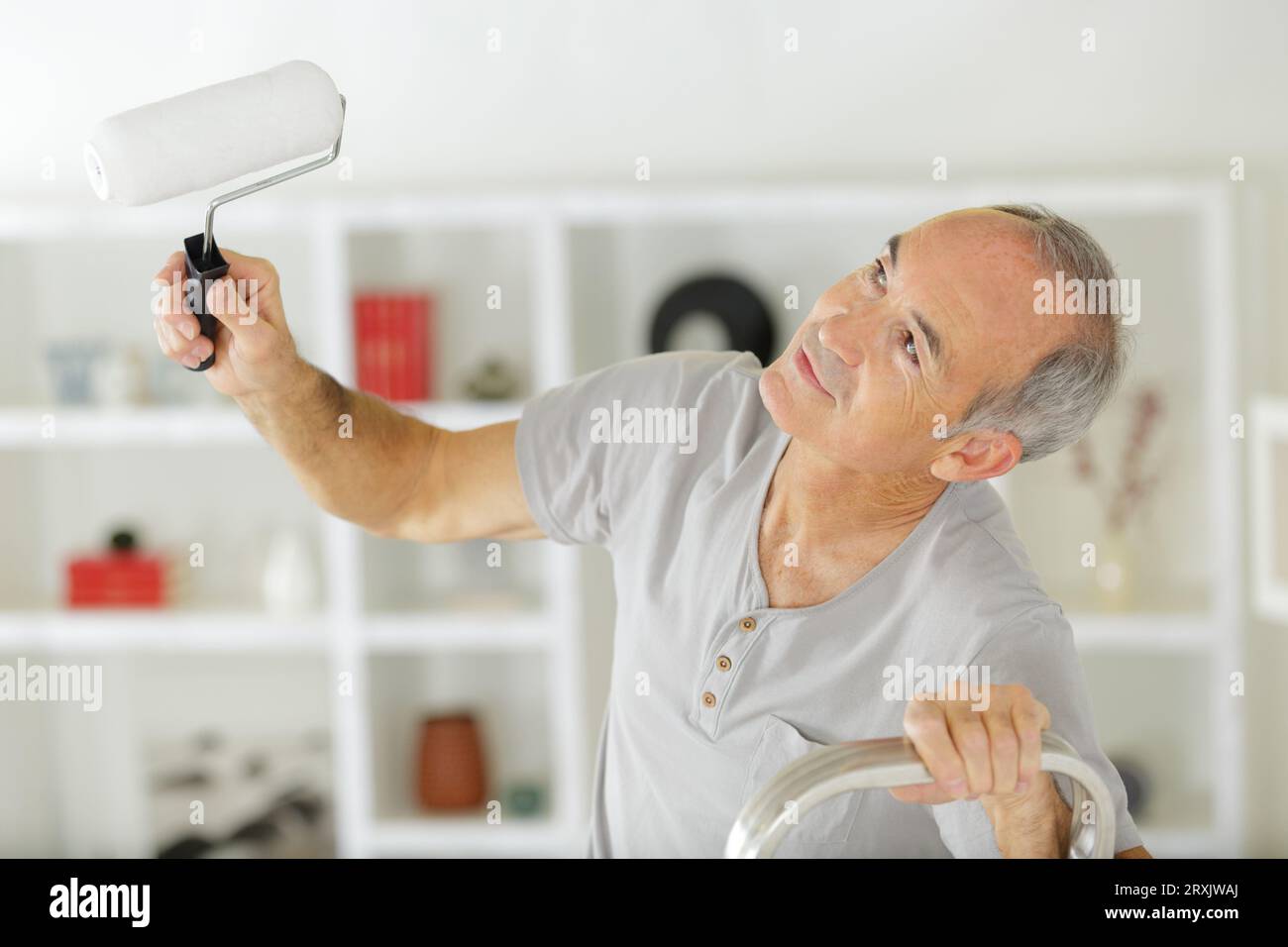 a senior man with roller Stock Photo - Alamy
