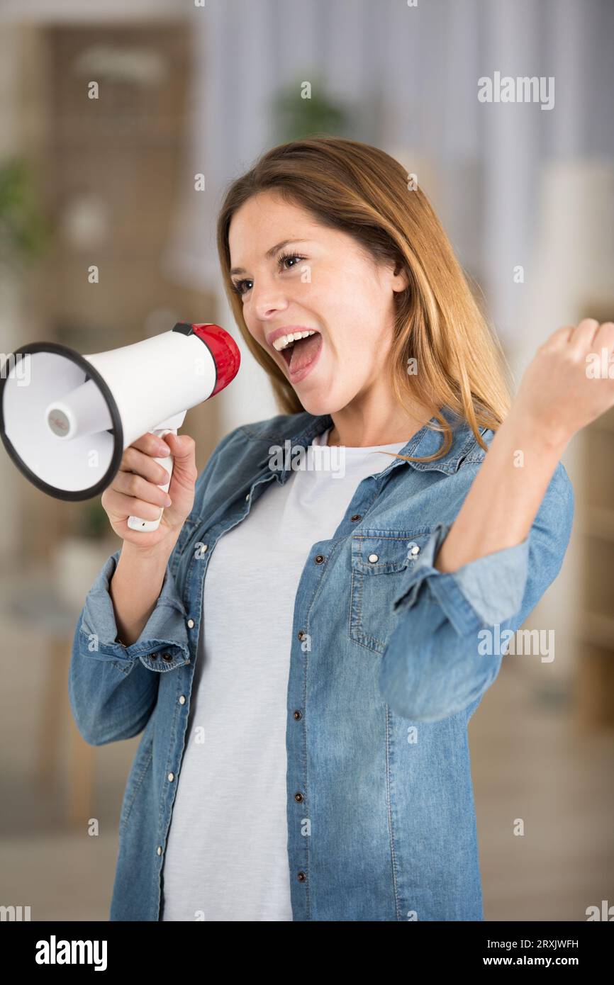 joyful woman making announcement through a megaphone Stock Photo - Alamy