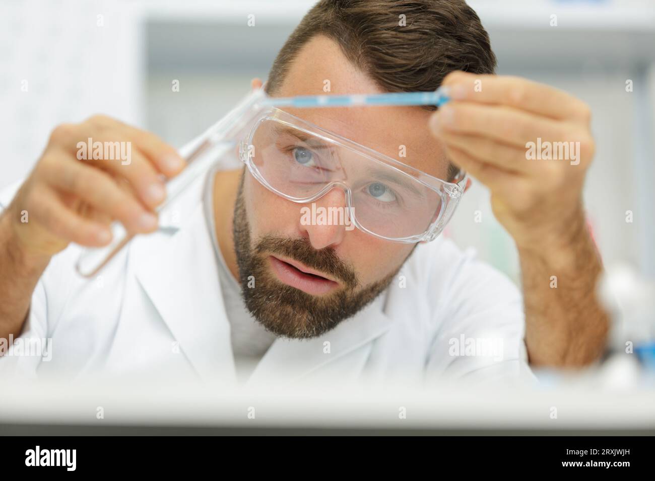 Laboratory technician filling test tubes hi-res stock photography and ...