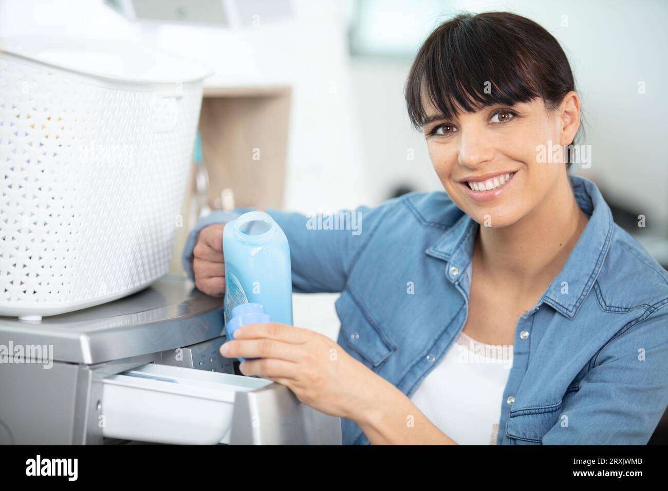 a happy housewife woman in laundry room with washing machine Stock ...