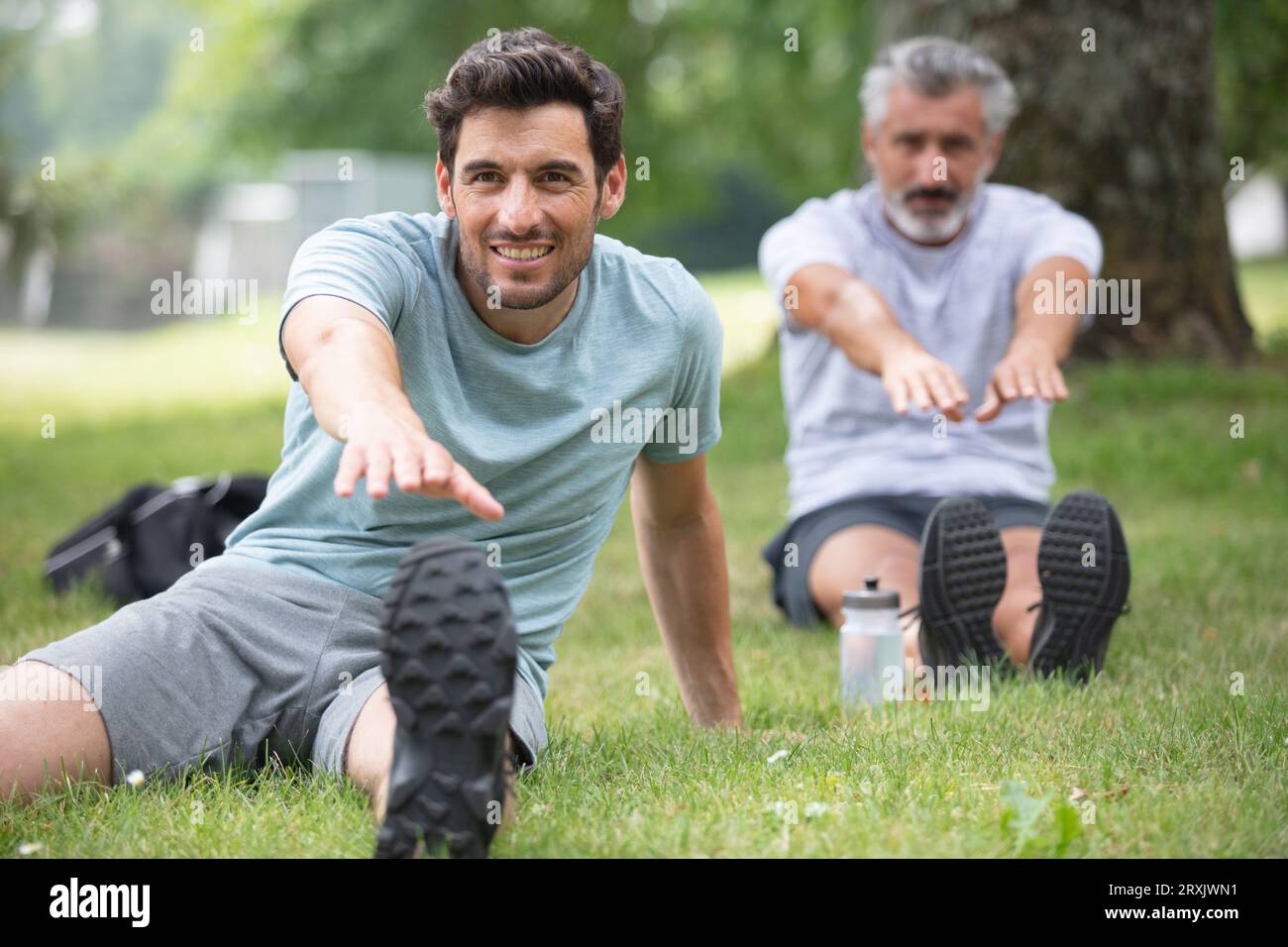 the two men doing exercise outdoor Stock Photo - Alamy