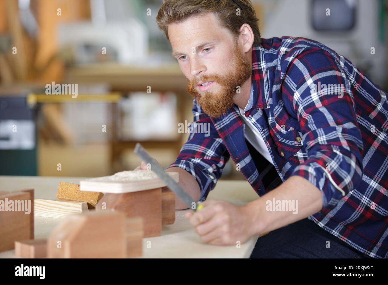 man sanding a wood with sander in a workshop Stock Photo - Alamy