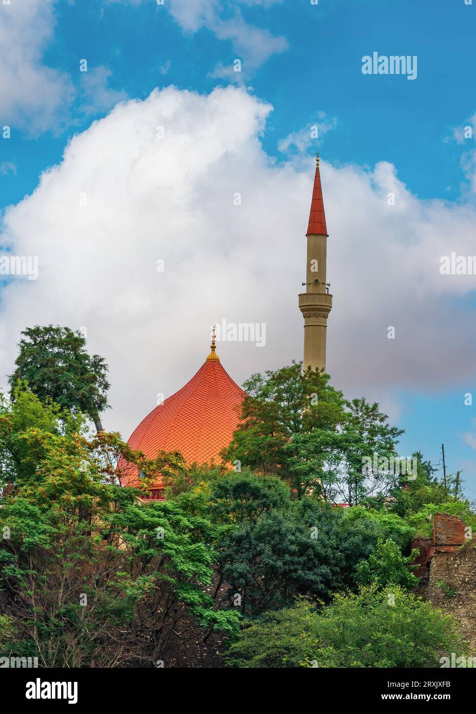 Mosque dome and minaret among green trees on the mountain Stock Photo ...