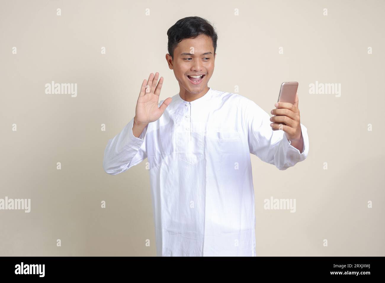 Portrait of attractive Asian muslim man in white shirt taking picture ...