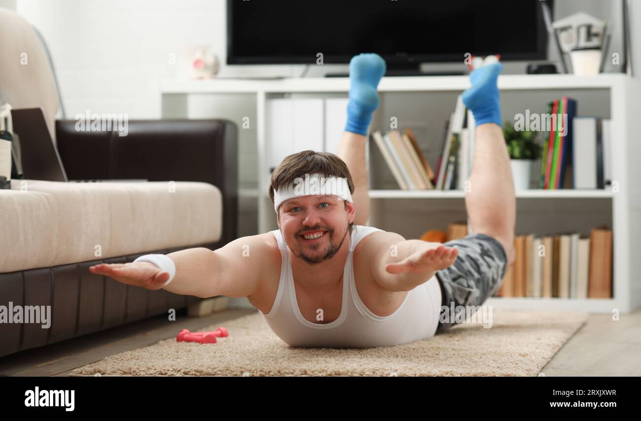 Young attractive fitness man lies on a fat mat with Stock Photo - Alamy