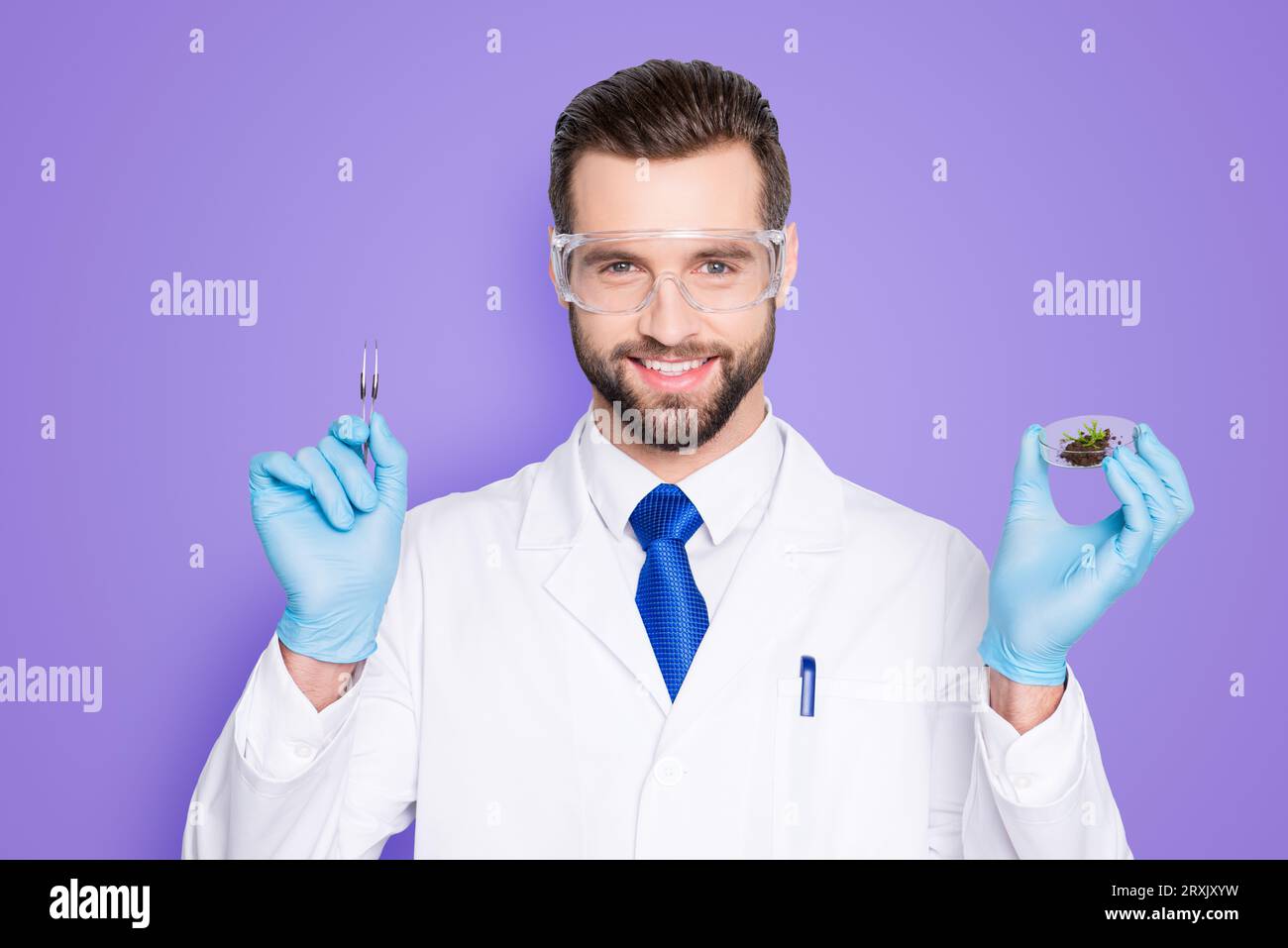 Portrait of attractive biologist in white outfit with tie, showing ...