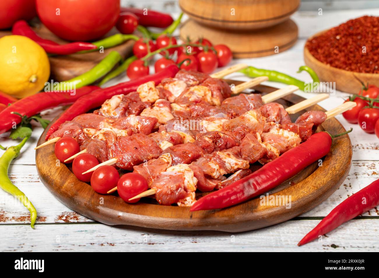 Lamb skewers on wood background. Raw lamb skewer with herbs and spices ...