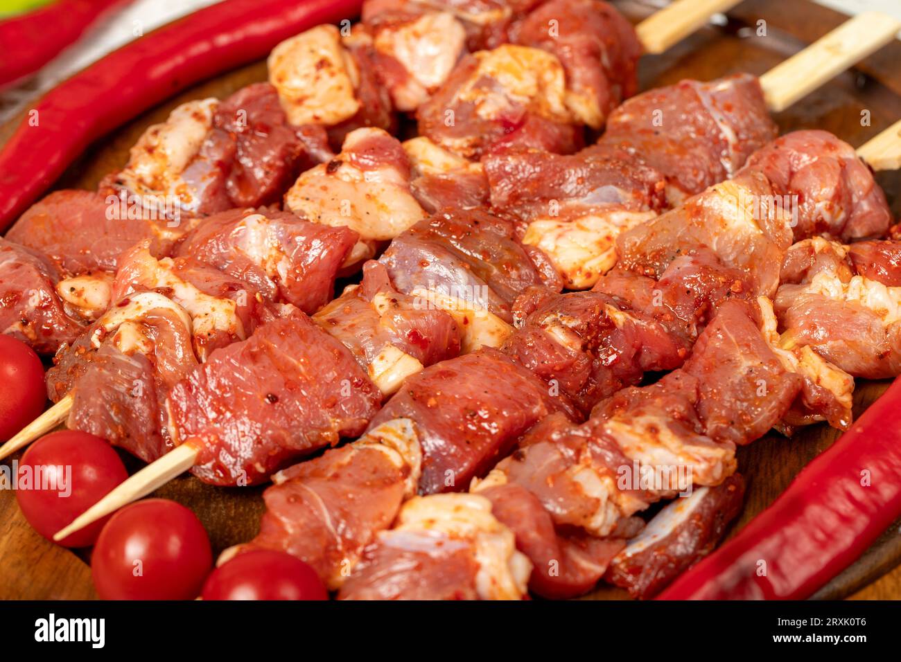 Lamb skewers on wood background. Raw lamb skewer with herbs and spices ...