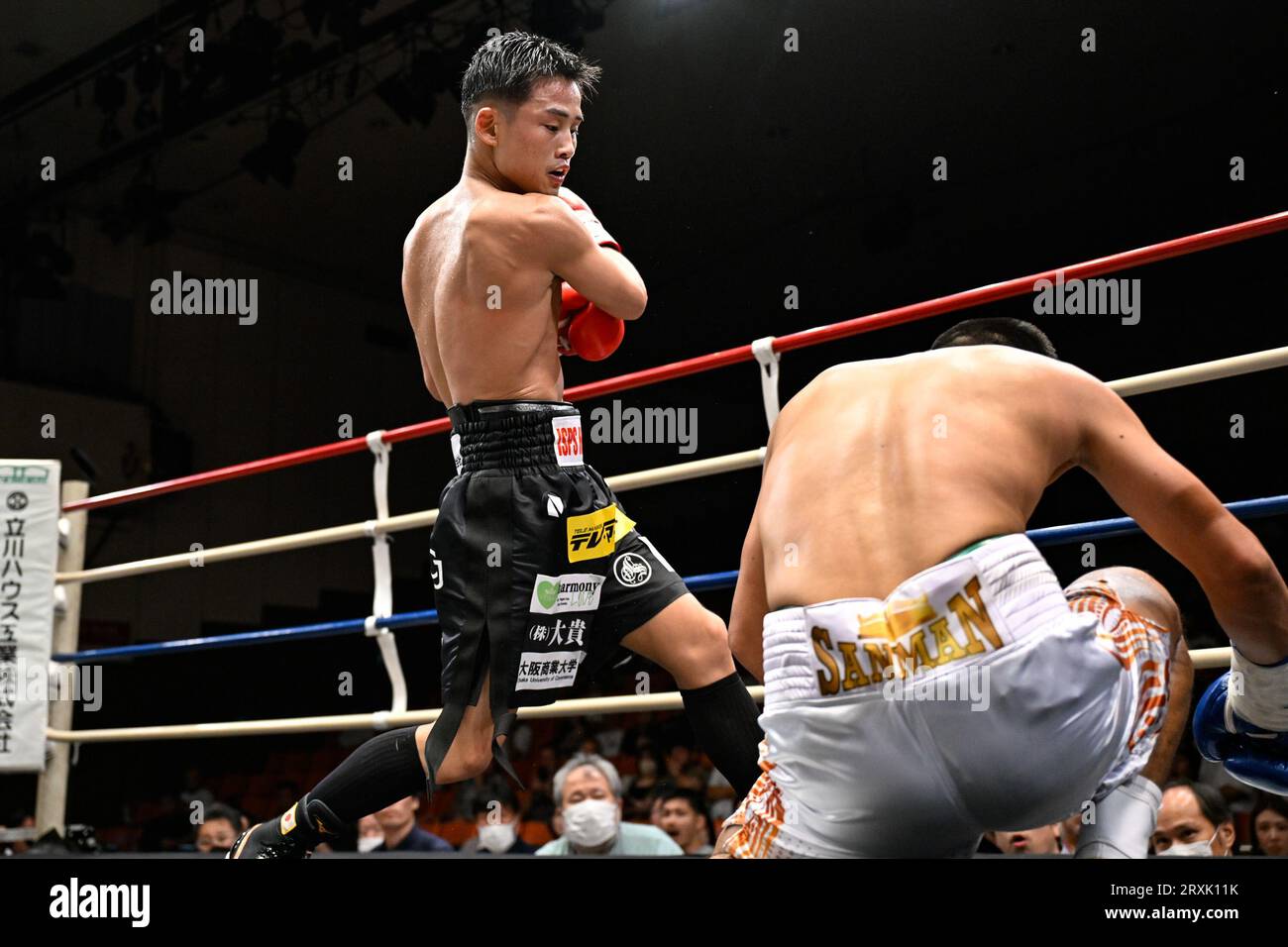 Hiroto Kyoguchi (red gloves) of Japan knocks down Jerven Mama (blue ...