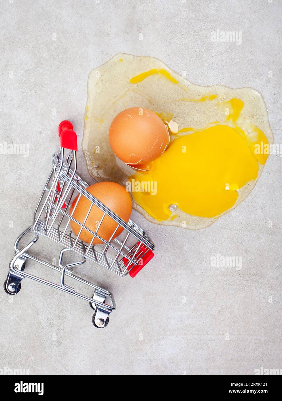 shopping cart with broken egg on light grey, egg shortage Stock Photo ...