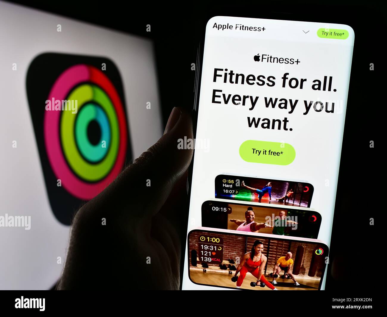 Person holding cellphone with webpage of exercise tracking app Apple ...