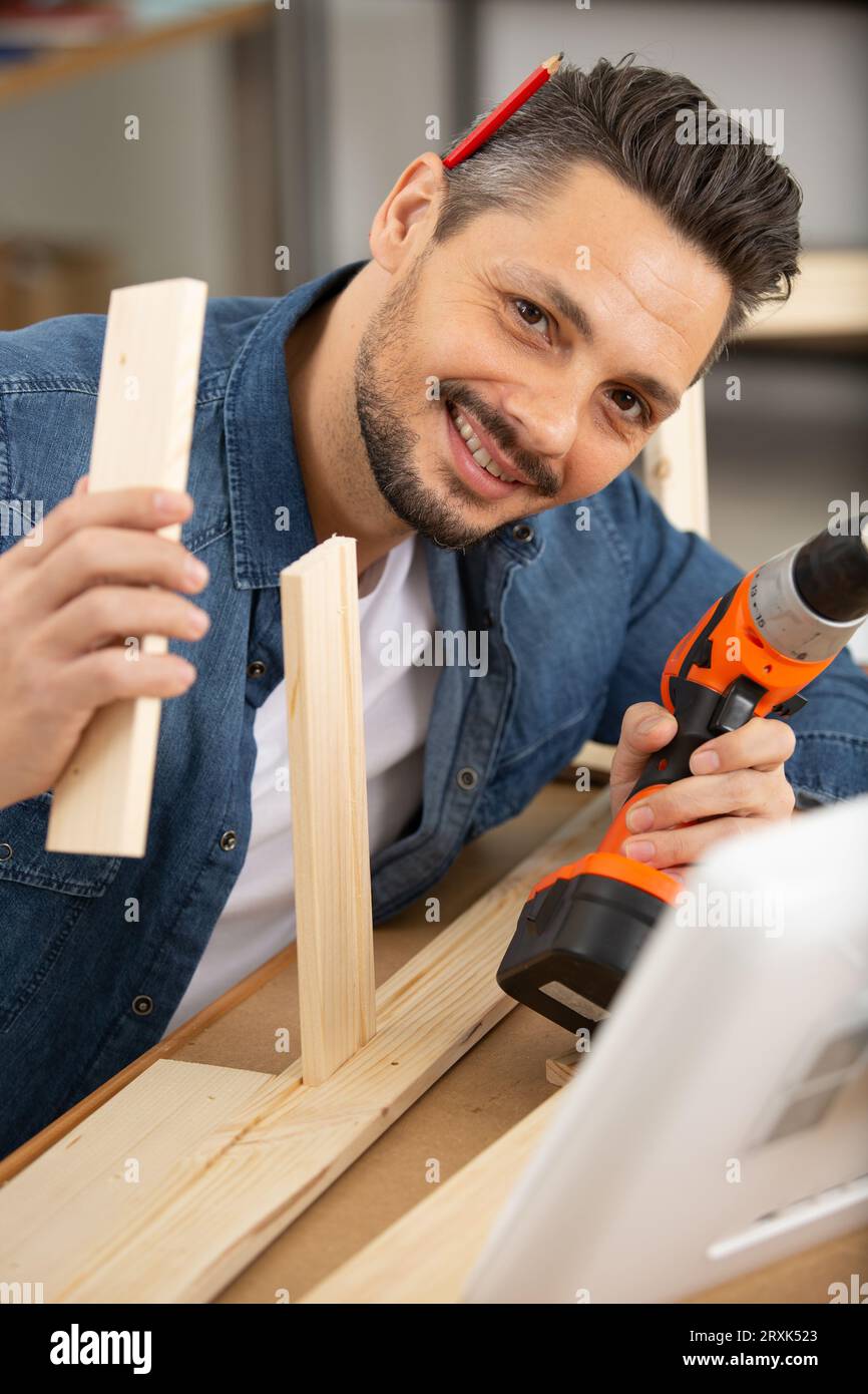 happy man and assemble of furniture Stock Photo - Alamy