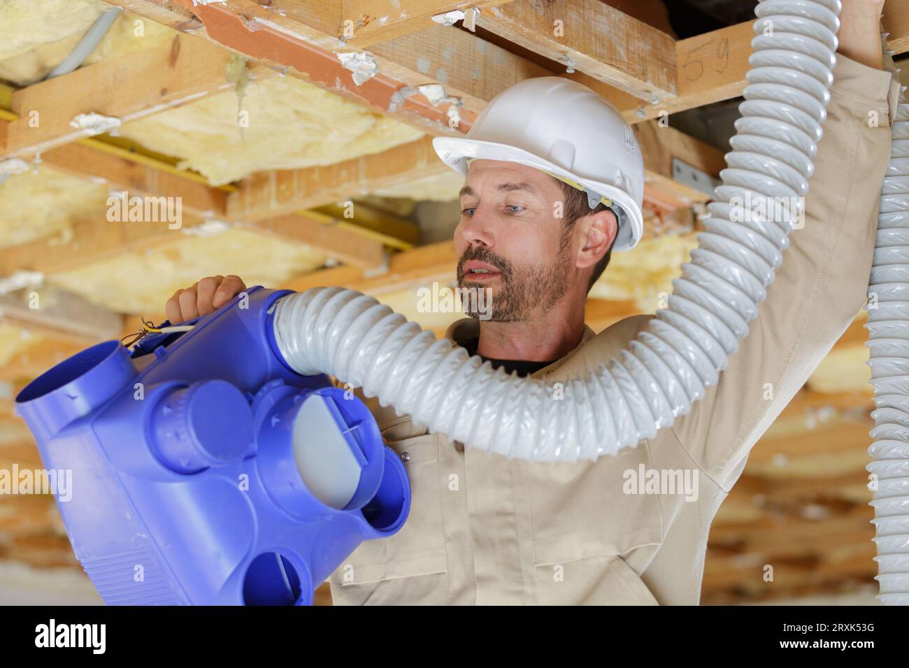 male worker assembling the ventilation box Stock Photo - Alamy