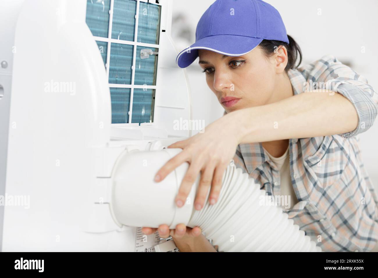 female electrician installing air conditioner Stock Photo - Alamy