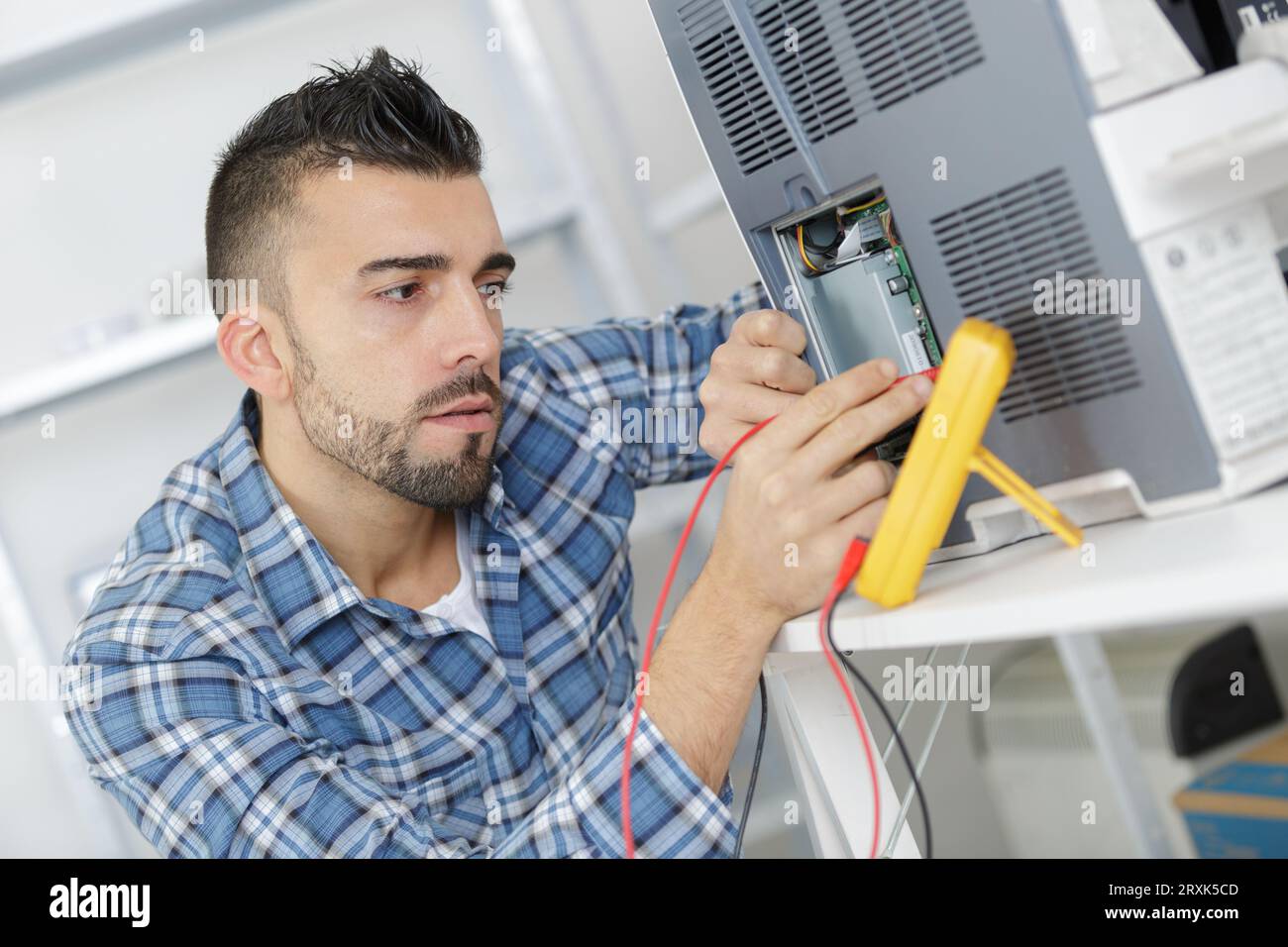 Young technician using multimeter hi-res stock photography and images ...