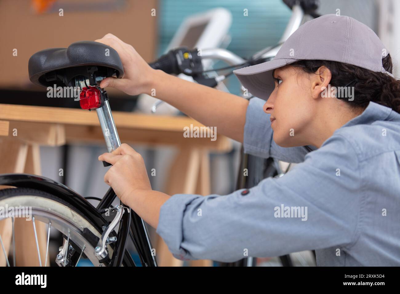 Female bike mechanic repairing hi-res stock photography and images - Alamy