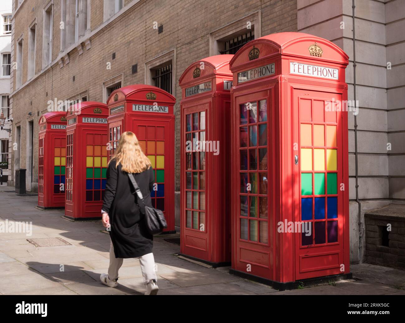 A row of classic K6 red phone boxes decorated with LGBTQ rainbow ...