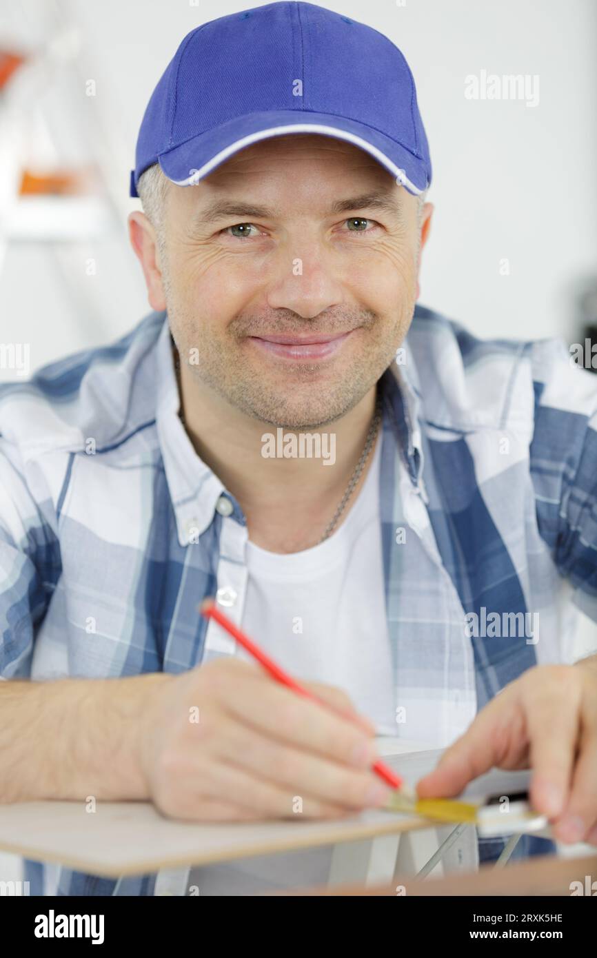 confident handsome male carpenter working with wood in his studio Stock ...
