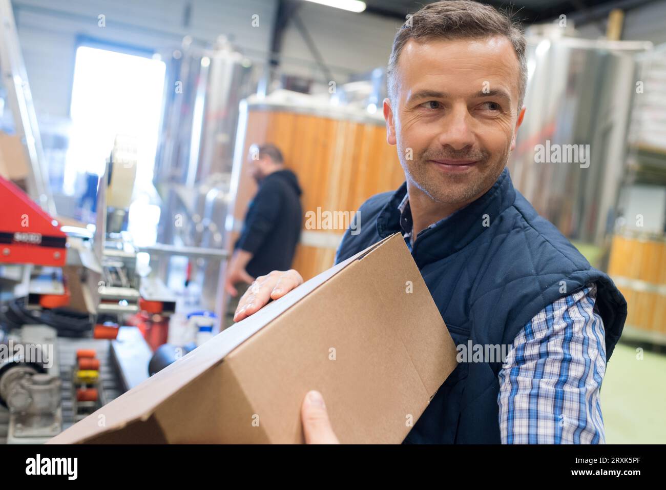 man holding cardboard box in factory dispatch department Stock Photo ...