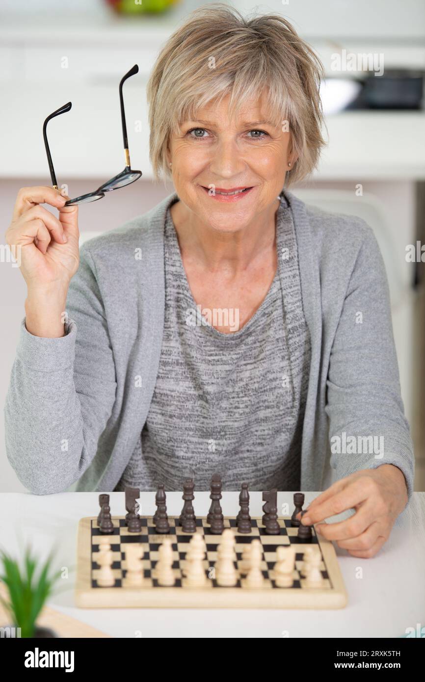 Old lady playing chess hi-res stock photography and images - Alamy