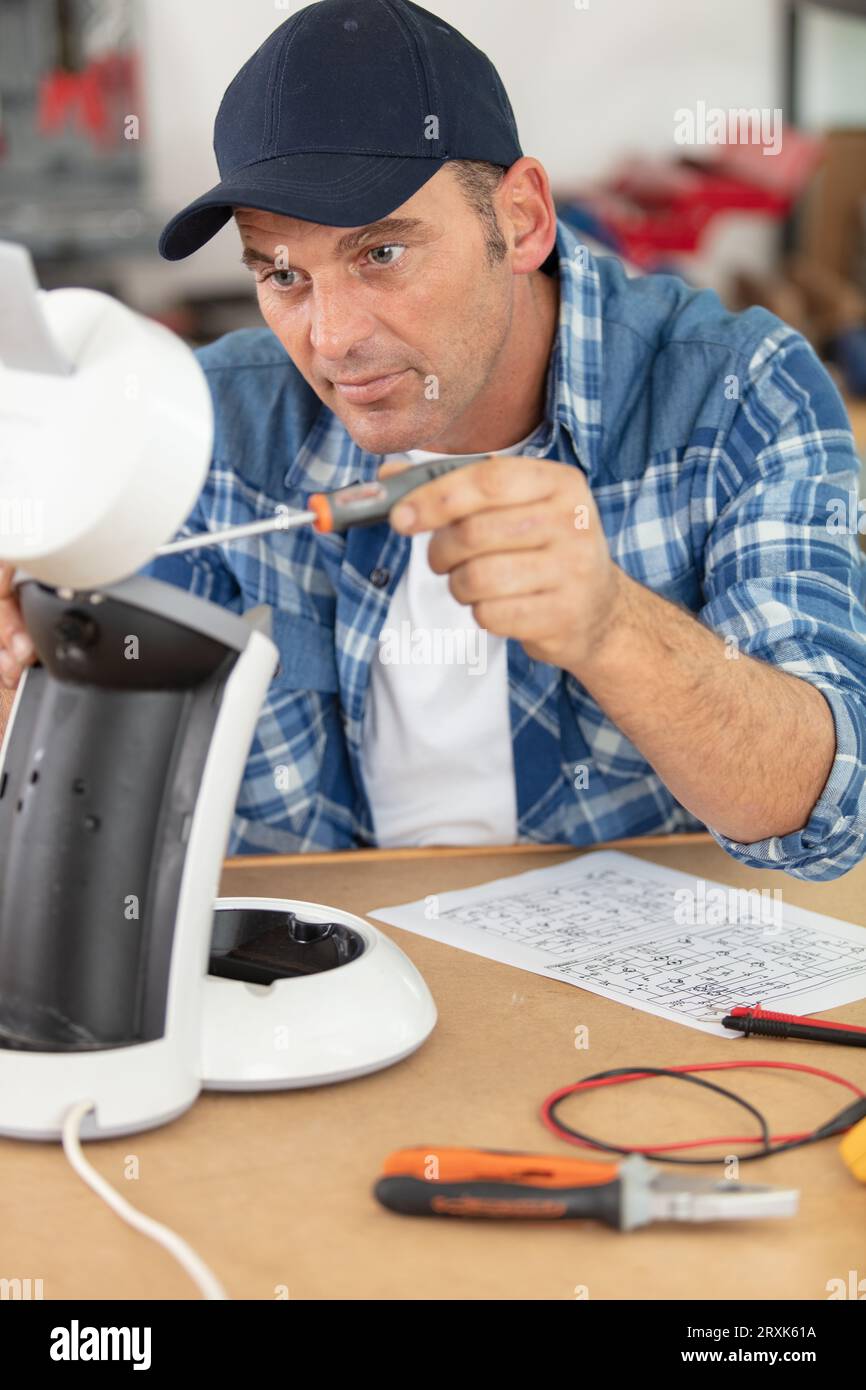 Adult handyman repairing coffee hi-res stock photography and images - Alamy