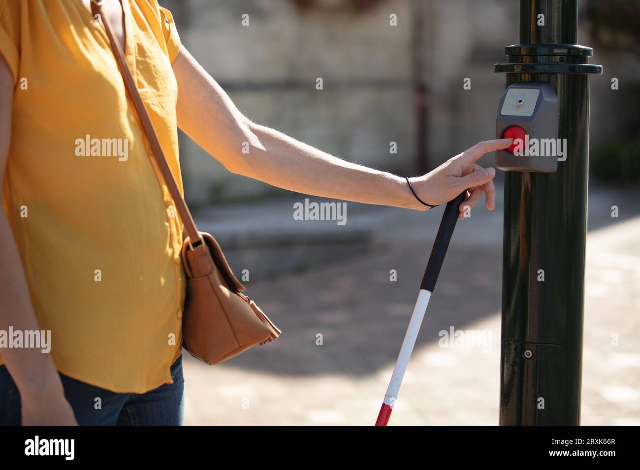 visually-impaired woman pressing button to cross the road Stock Photo ...