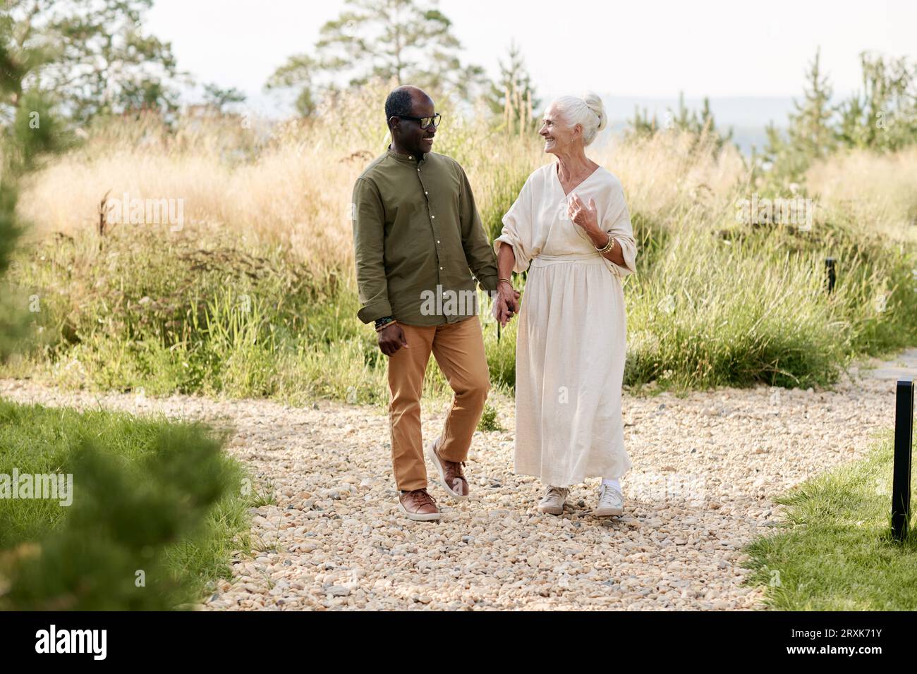 Happy senior couple holding hands and enjoying their walk together ...