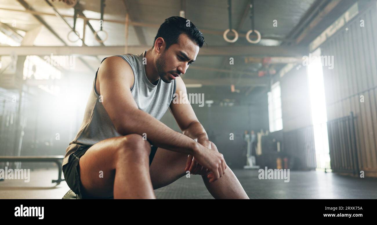 Fitness, breathing and sweating with a tired man in the gym, resting ...