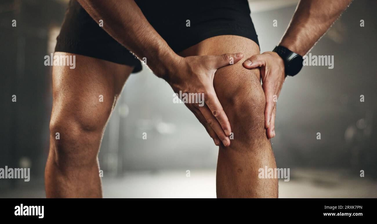 Fitness, knee pain and hands of man at gym for training with muscle ...