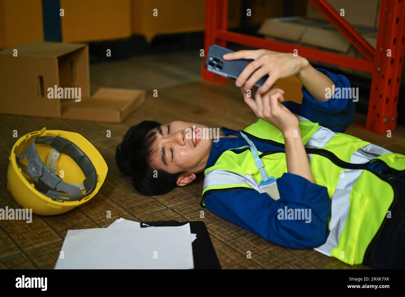 Male worker trying to making an emergency call, asking for first aid ...