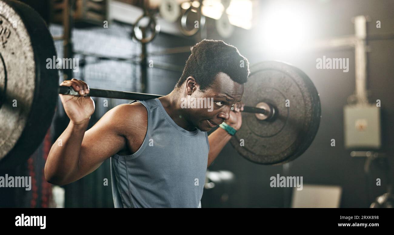 Black man at gym, weight lifting and barbell for muscle building ...