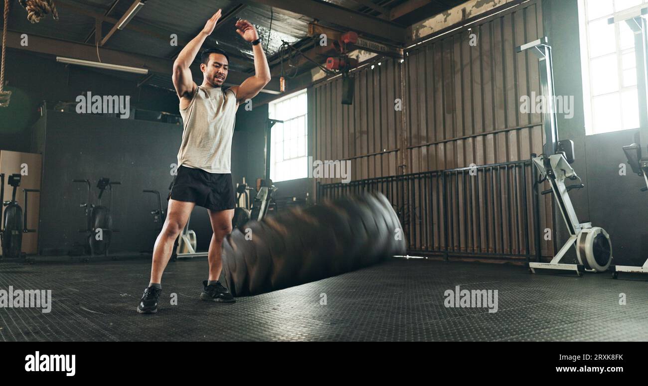 Gym, man and tire workout for strong muscle, power and action of sports ...