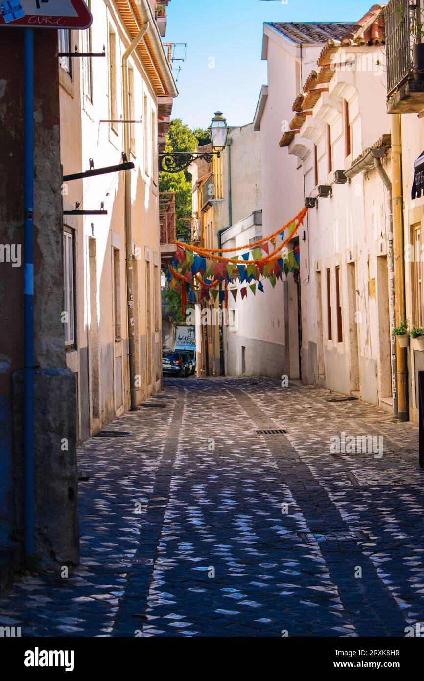 Festive street decoration in Lisbon, Polrugal. Narrow medieval street ...