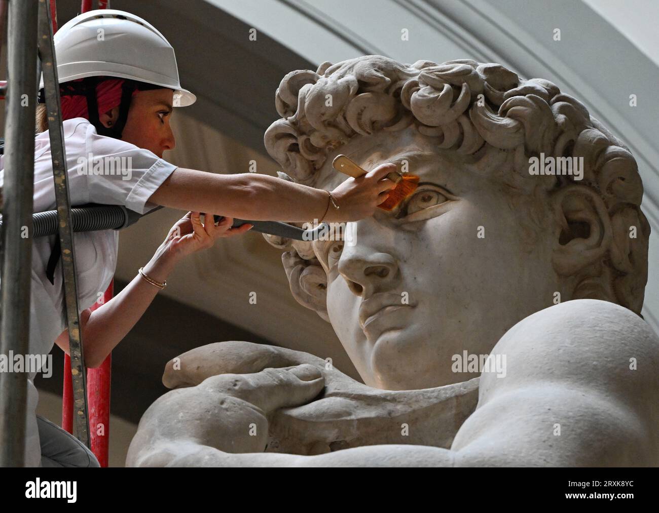 Italian Restorer Eleonora Pucci cleans dust and debris off Michelangelo ...