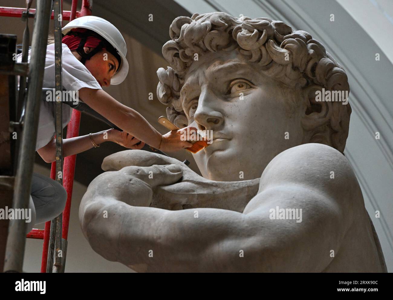 Italian Restorer Eleonora Pucci cleans dust and debris off Michelangelo ...