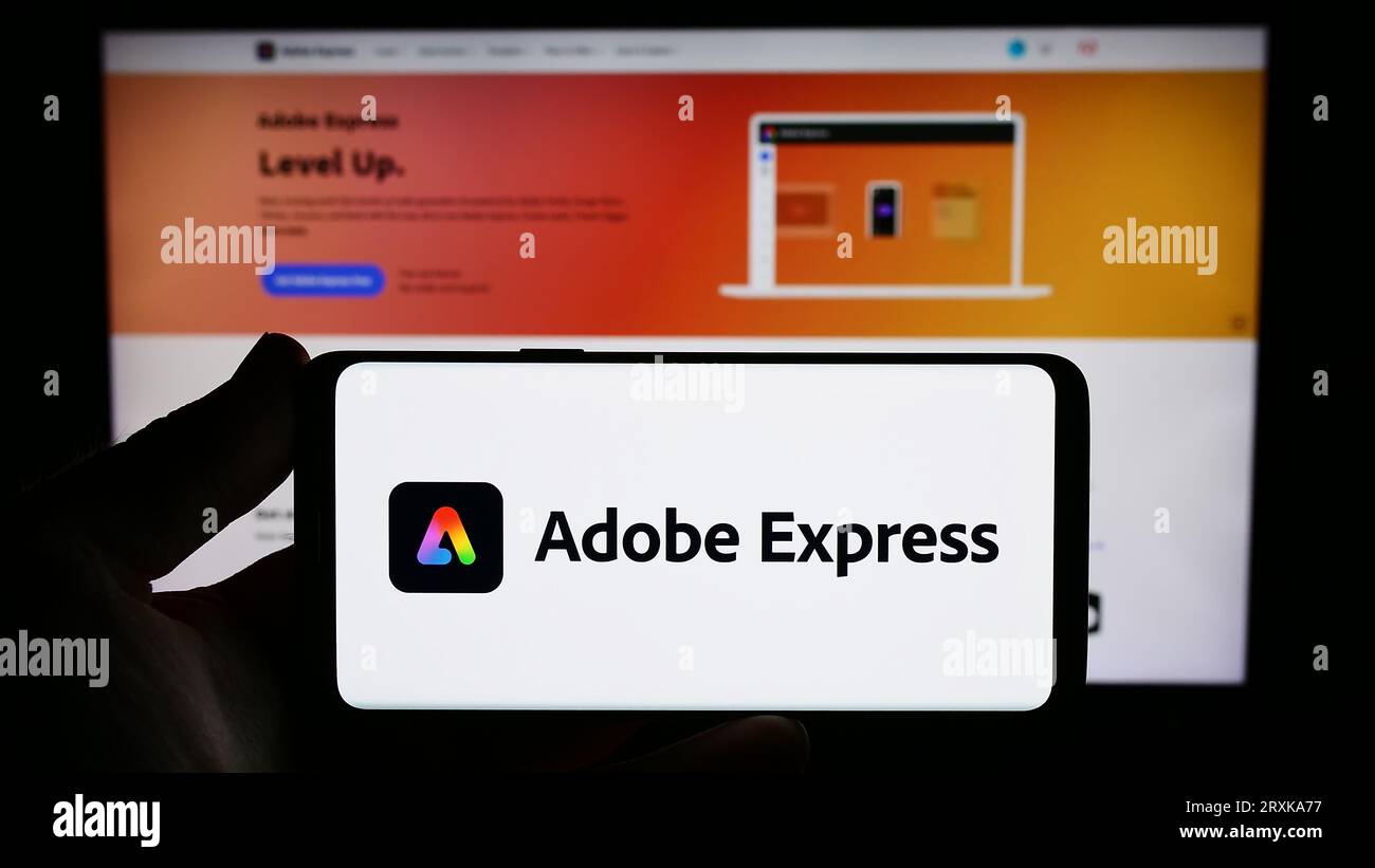 Person holding smartphone with logo of graphics design software Adobe ...