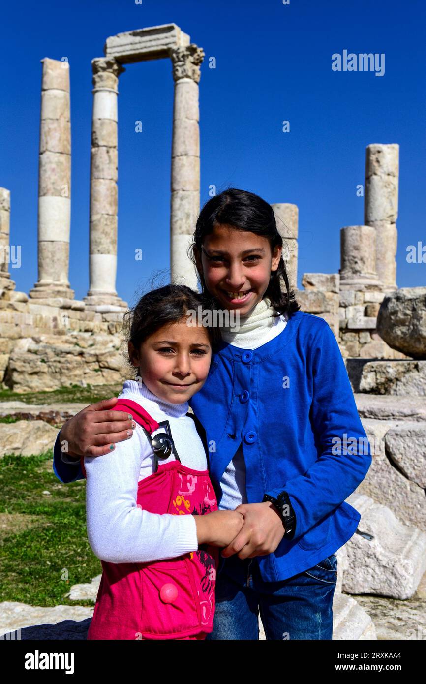 Cute local girls asked to pose for a photo at the Temple of Hercules, a ...