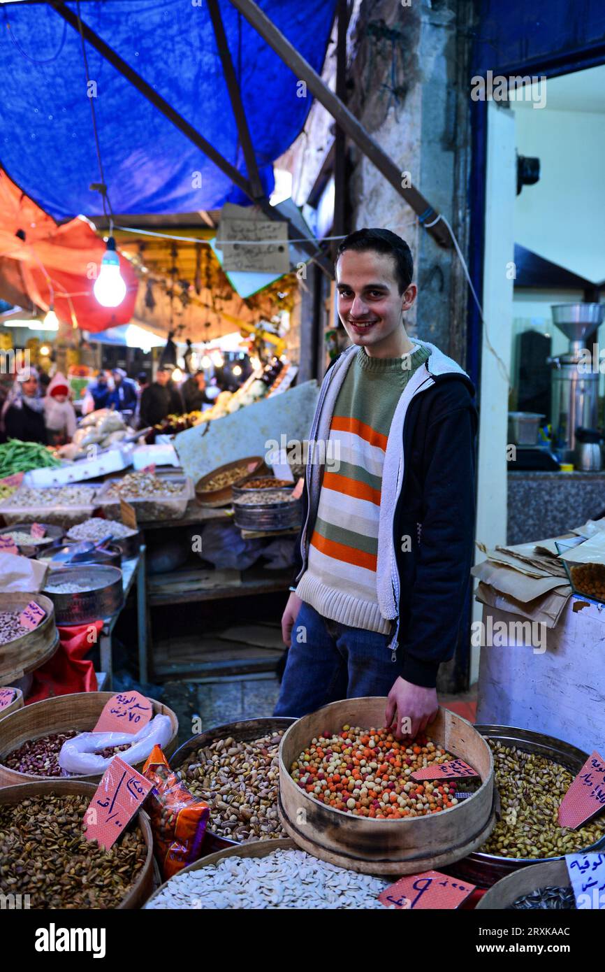 A friendly shopkeeper asked to pose for a photo in Souk al Khodra ...